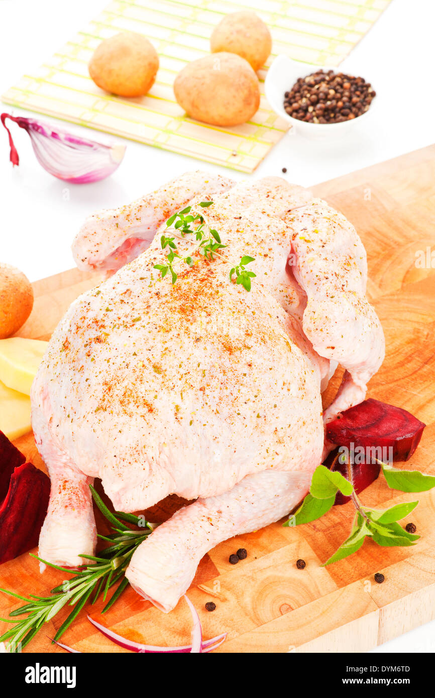 Whole chicken on kitchen board ready to baking. Delicious traditional ...