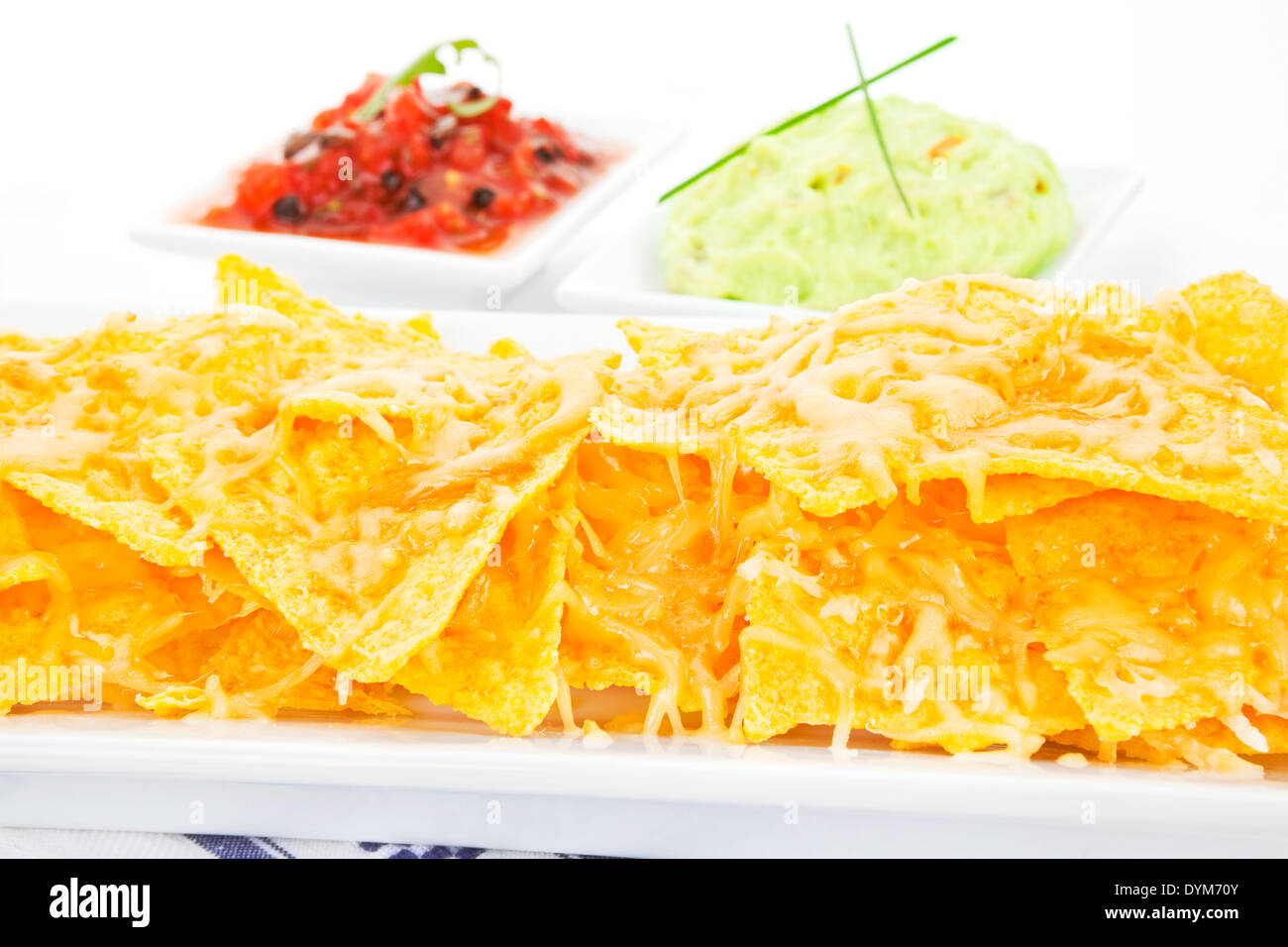 Delicious nachos baked with cheese close up Stock Photo - Alamy