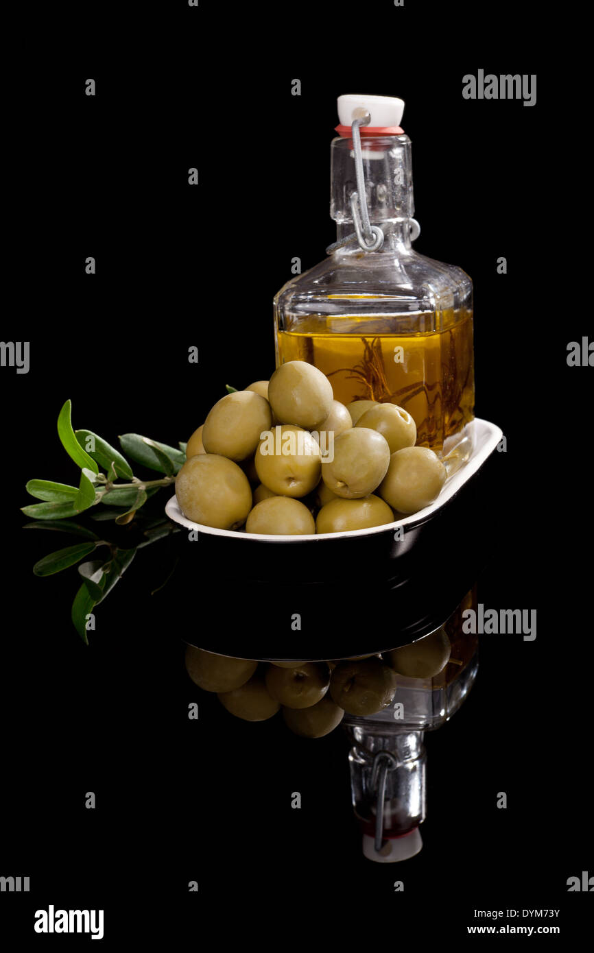 Luxurious virgin olive oil with fresh olives and olive branch isolated ...