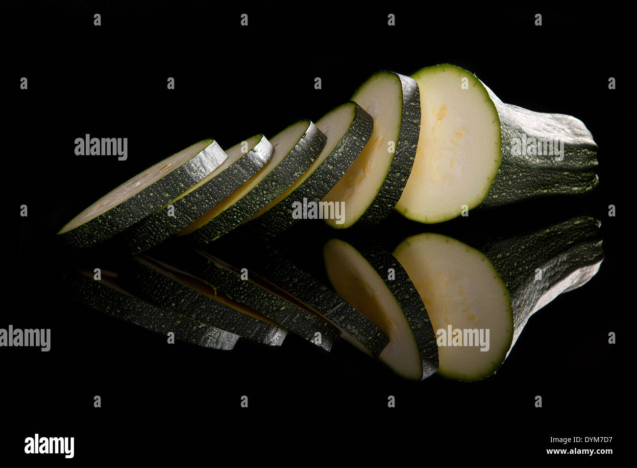 Delicious raw fresh zucchini slices isolated on black background with ...