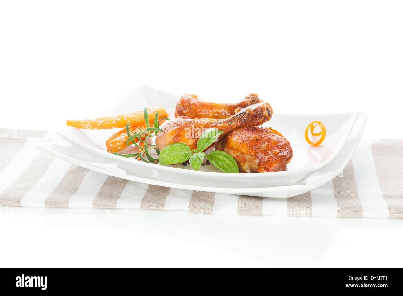 Delicious chicken legs plate with fresh herbs and vegetable. Culinary ...