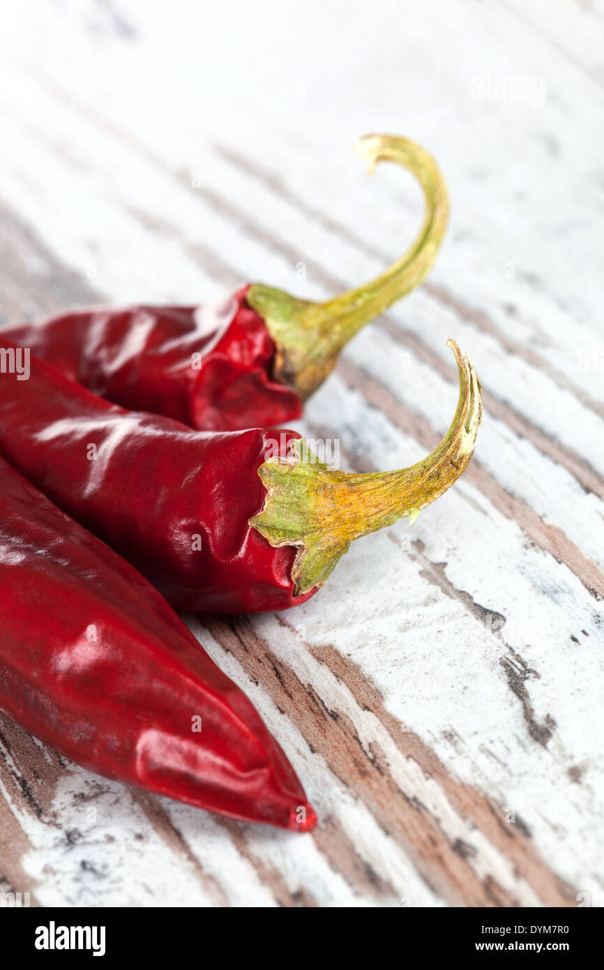 Luxurious chili pepper background. Three dried chili pepper on white ...