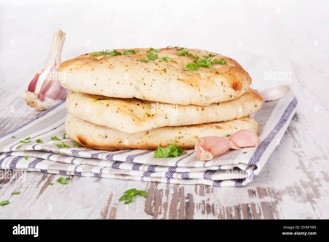 Luxurious naan background. Naan flat bread pile with fresh parsley herb ...