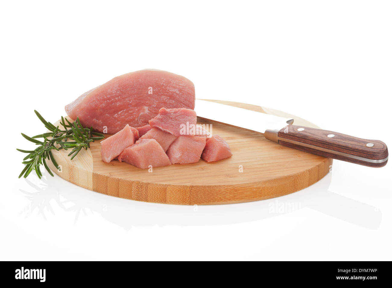Raw pork piece with fresh rosemary and knife on round wooden kitchen ...