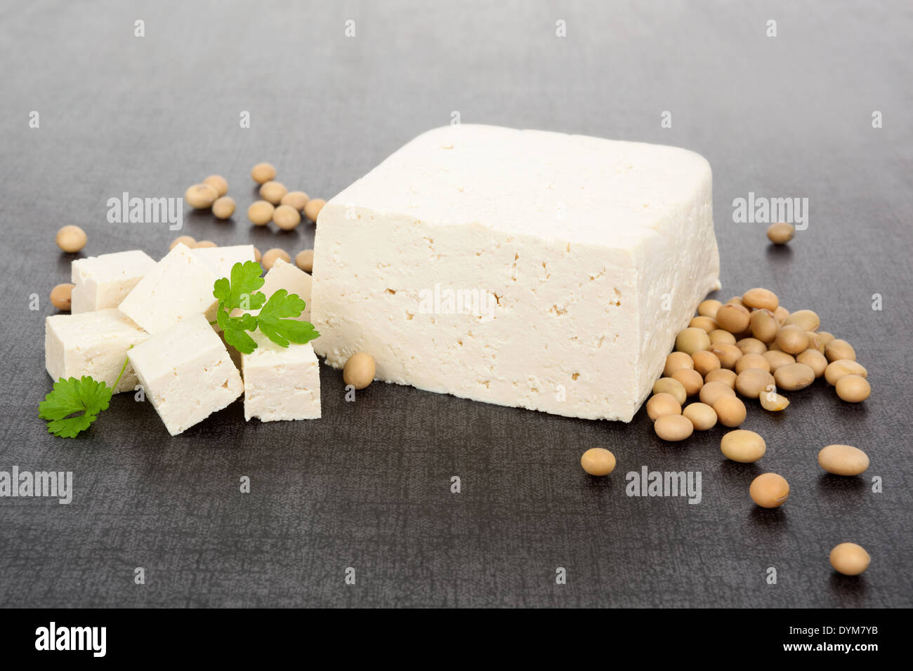Tofu and soybeans on black and grey background. Culinary luxurious ...