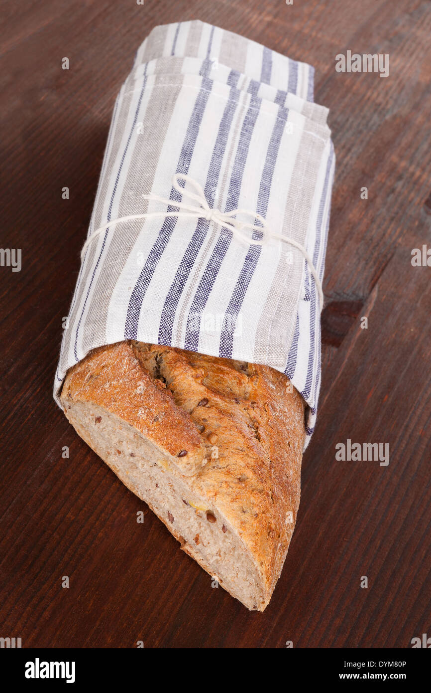 Luxurious dark brown baguette on wooden background, rustic style ...