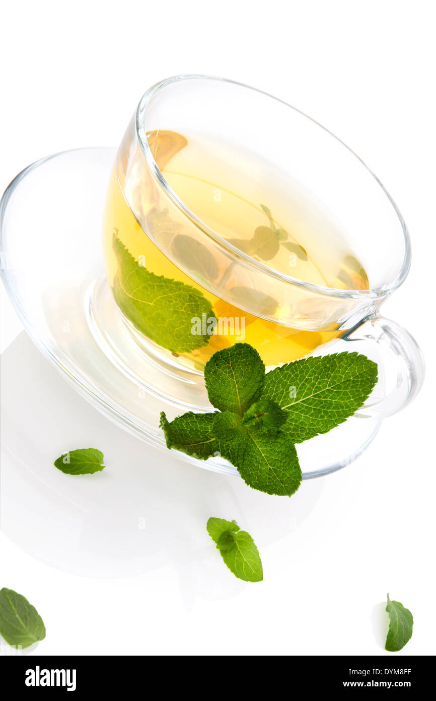 Delicious fresh mint tea with fresh leaves in transparent cup with ...