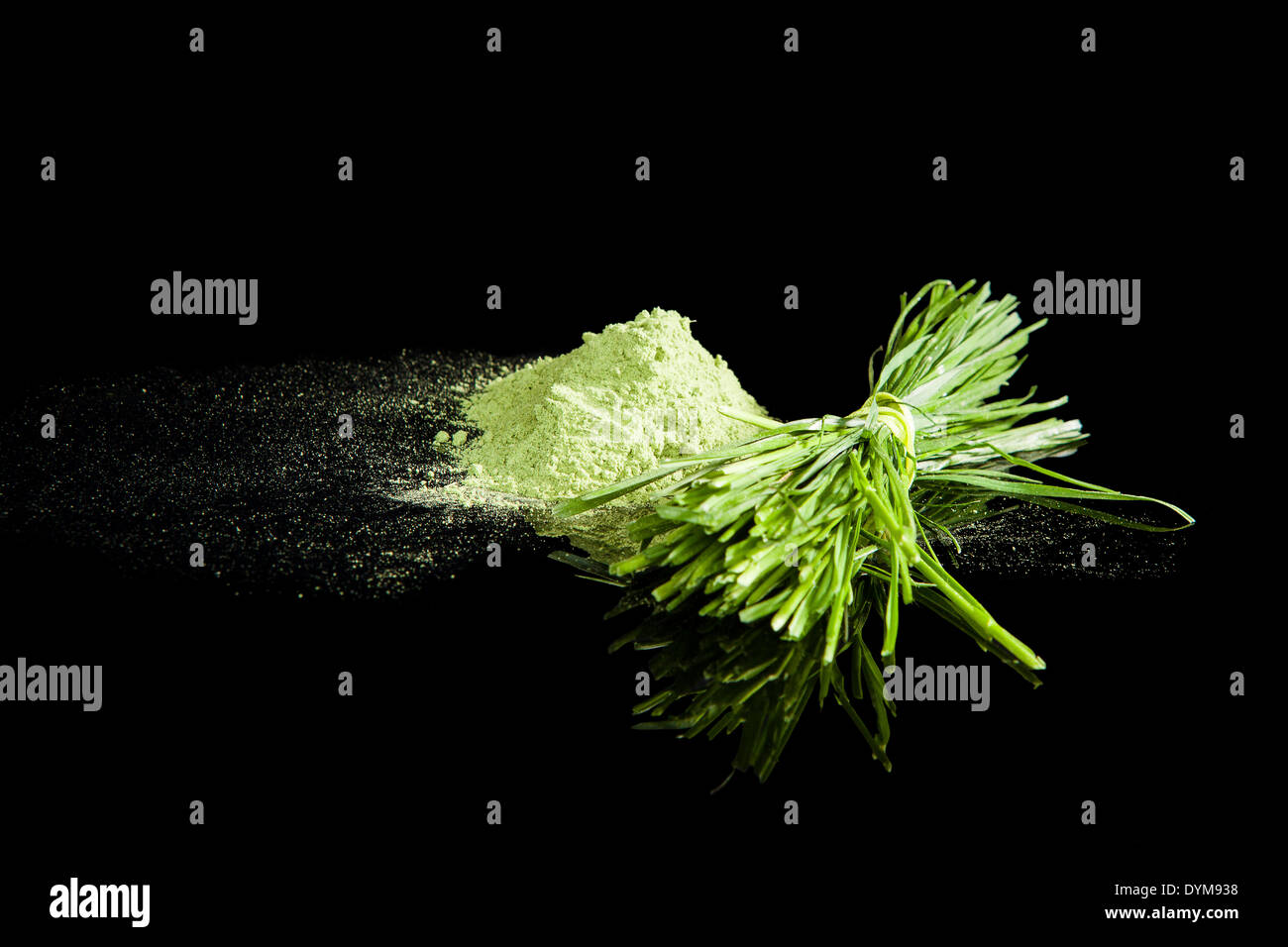 Wheatgrass powder and fresh wheatgrass bundle isolated on black ...
