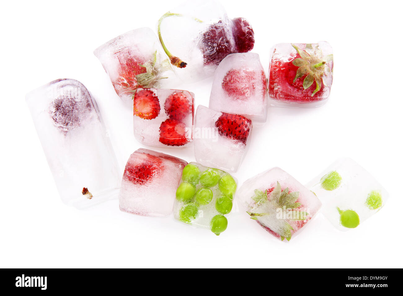 Fresh delicious summer fruit and vegetable frozen in ice cubes isolated ...