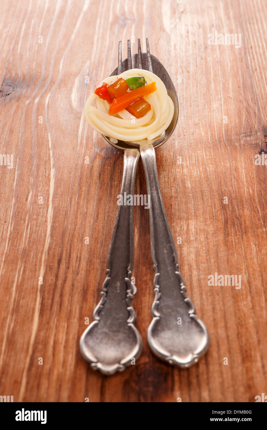 Culinary pasta eating. Pasta with colorful vegetable on silver spoon ...