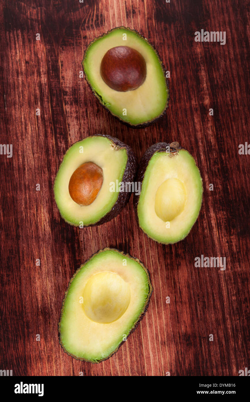Ripe avocado fruit also known as alligator pear halves, few with core ...