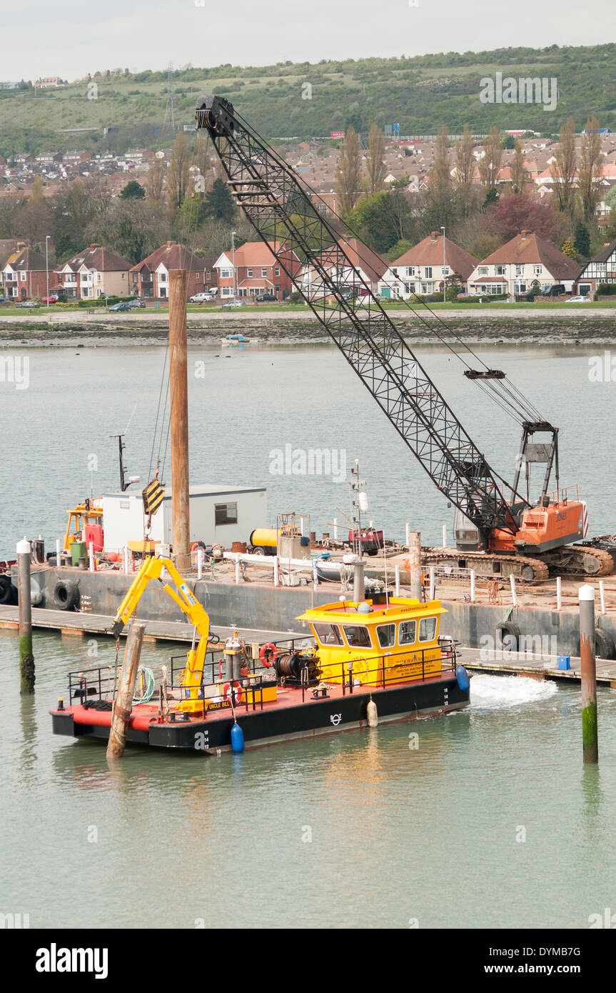 work boat and crane building a marine jetty Stock Photo - Alamy