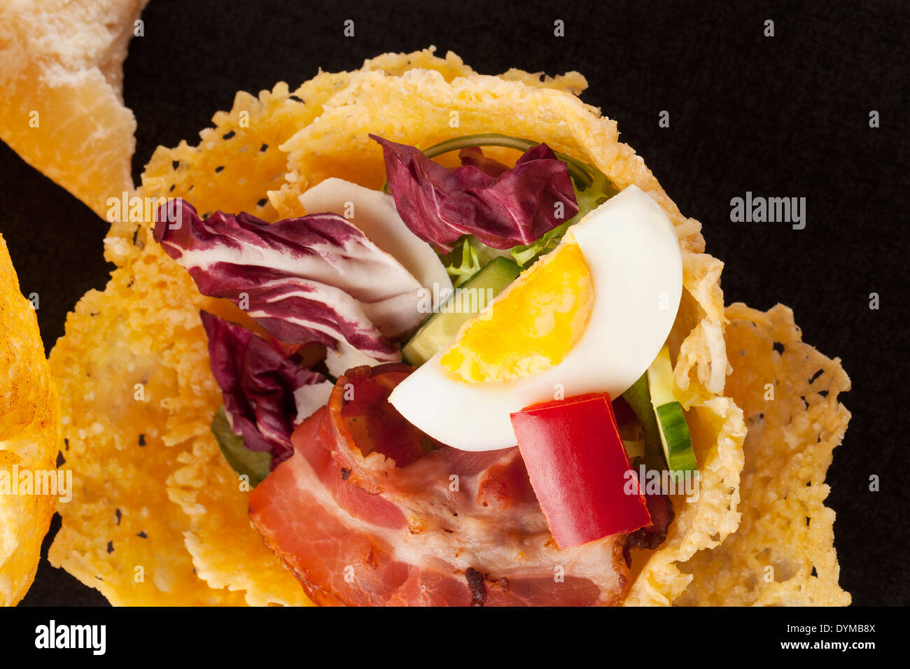 Parmigiano cheese basket filled with bacon and fresh vegetable ...
