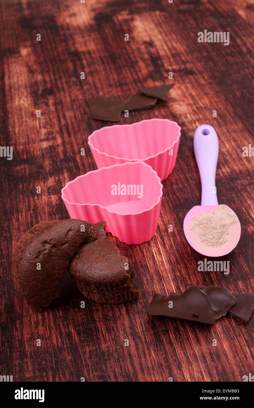 Chocolate muffin, chocolate bar, baking form and baking mixtures on ...