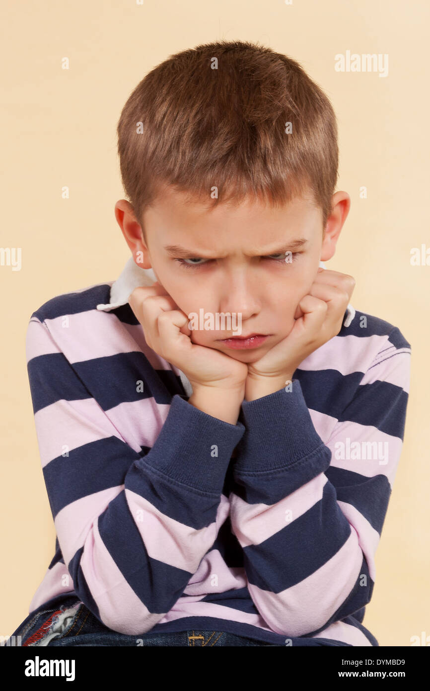 Little angry boy isolated on neutral background. Facial expressions ...