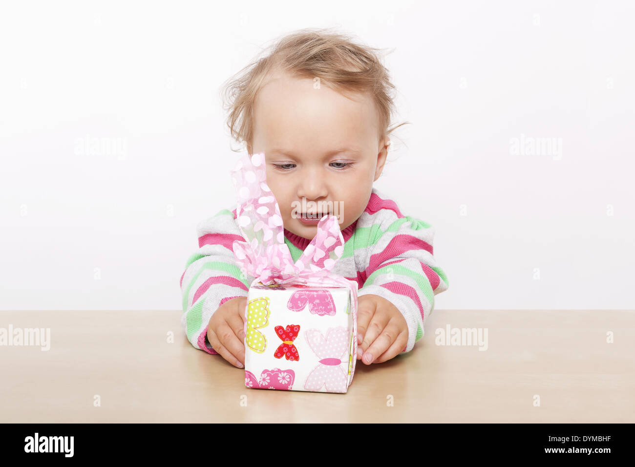 Birthday surprise. Cute baby girl opening present isolated on white ...