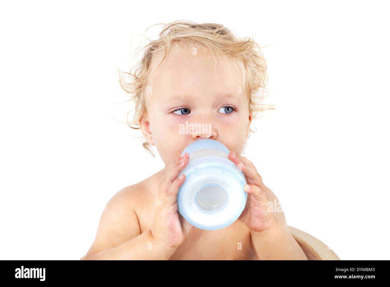 Cute blonde curly baby girl drinking milk from baby battle isolated on ...