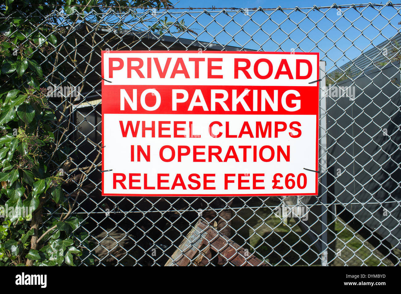 Wheel clamping warning sign Stock Photo - Alamy