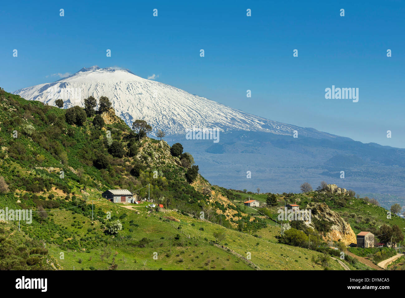 Snowy western flank of volcano Mount Etna seen from hill country near ...