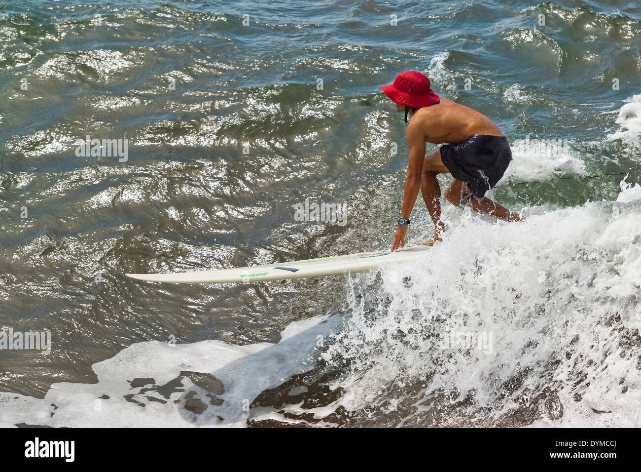 Surfer on a wave at this popular point break surf spot & small resort ...