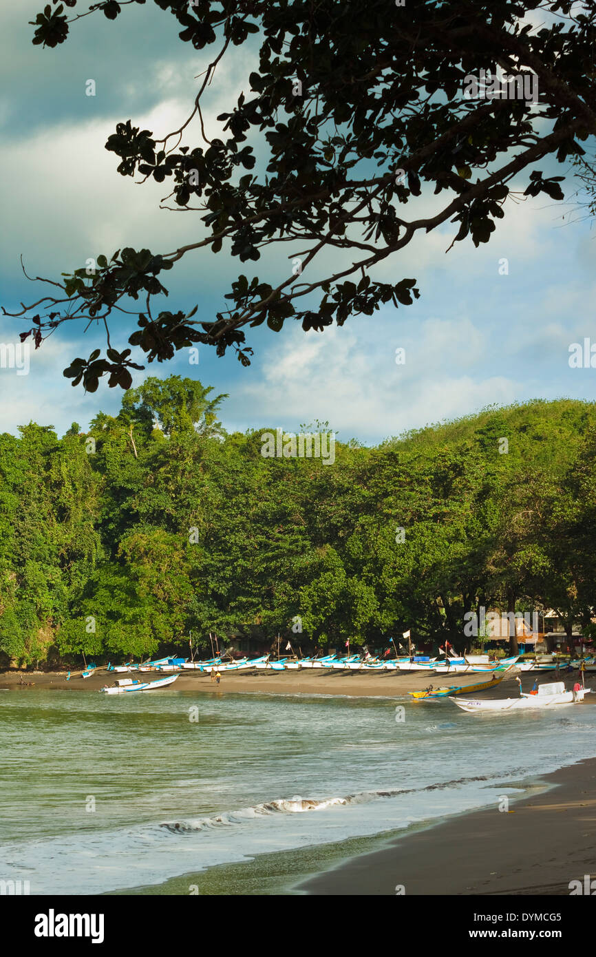 View across the bay to this popular surf beach & small resort; Batu ...