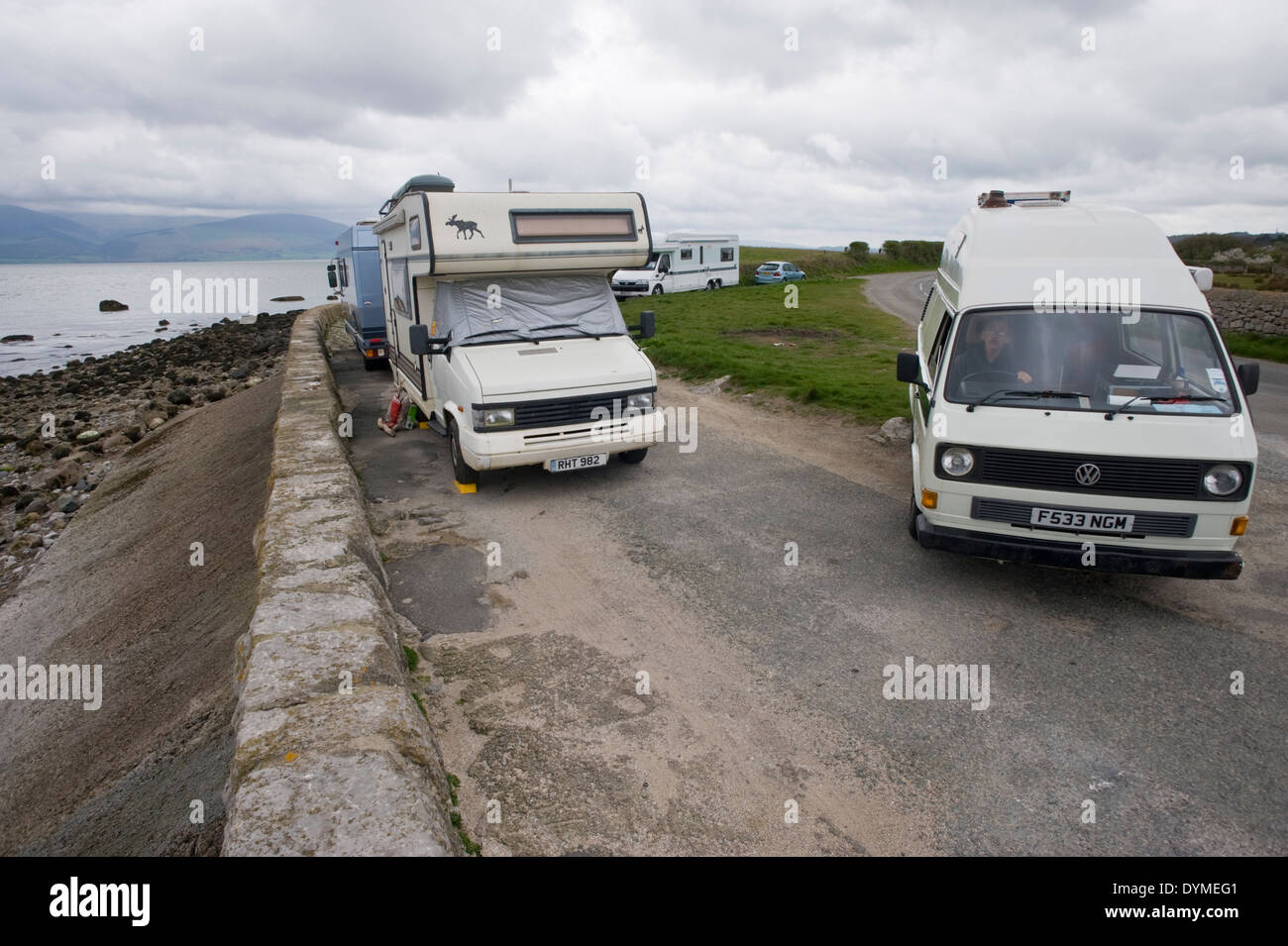 Camper vans pulled up in coastal layby at Penmon on Anglesey North ...