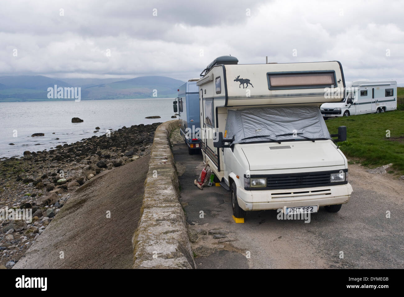 Camper vans pulled up in coastal layby at Penmon on Anglesey North ...