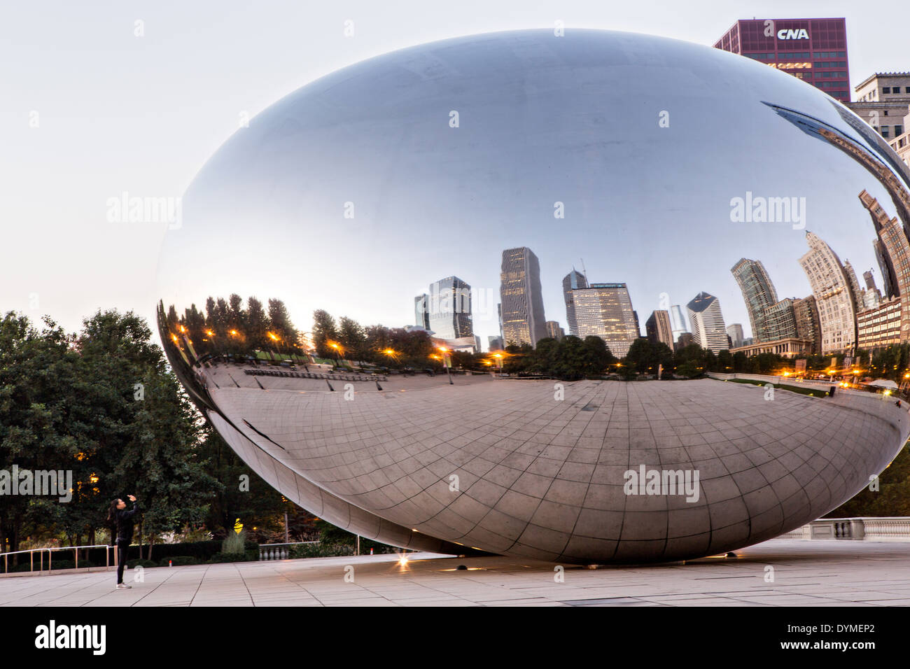 Cloud Gate Sculpture or The Bean with downtown skyline reflected in ...