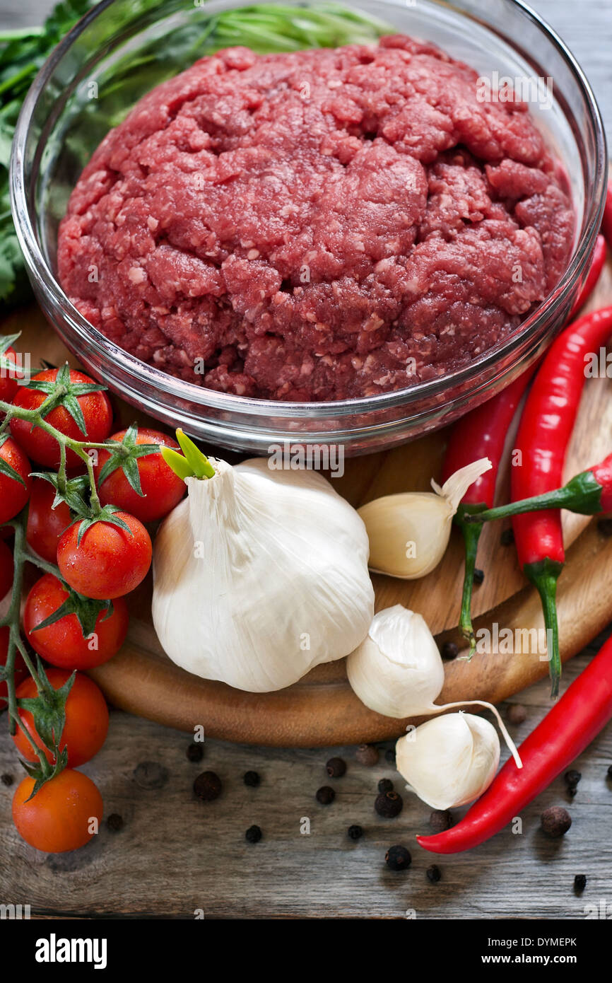Minced meat, chili pepper, cherry tomato and garlic. Selective focus ...