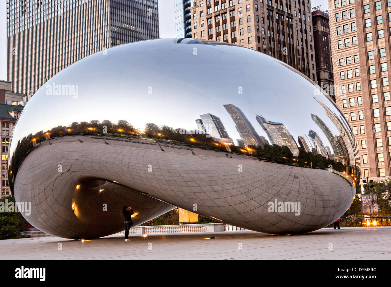 Cloud Gate Sculpture or The Bean with downtown skyline reflected in ...