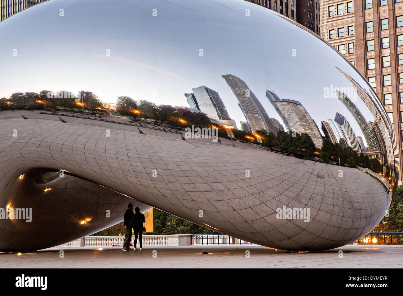 Cloud Gate Sculpture or The Bean with downtown skyline reflected in ...