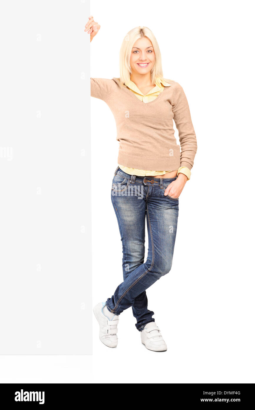 Young woman standing next to a blank panel Stock Photo - Alamy