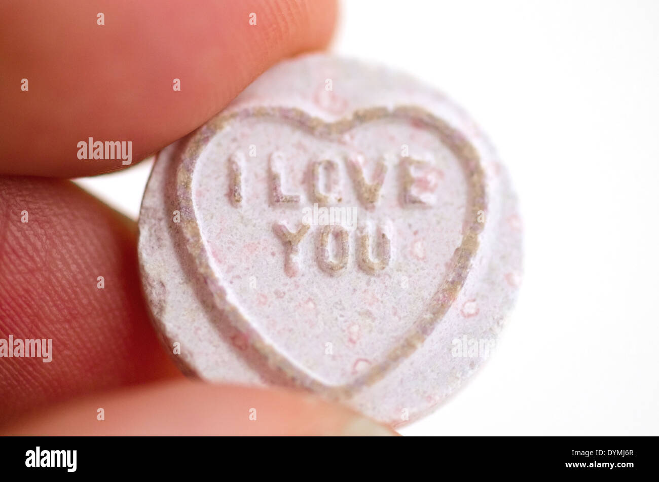 Hand holding a Love Heart Sweet saying 'I Love You' Stock Photo - Alamy