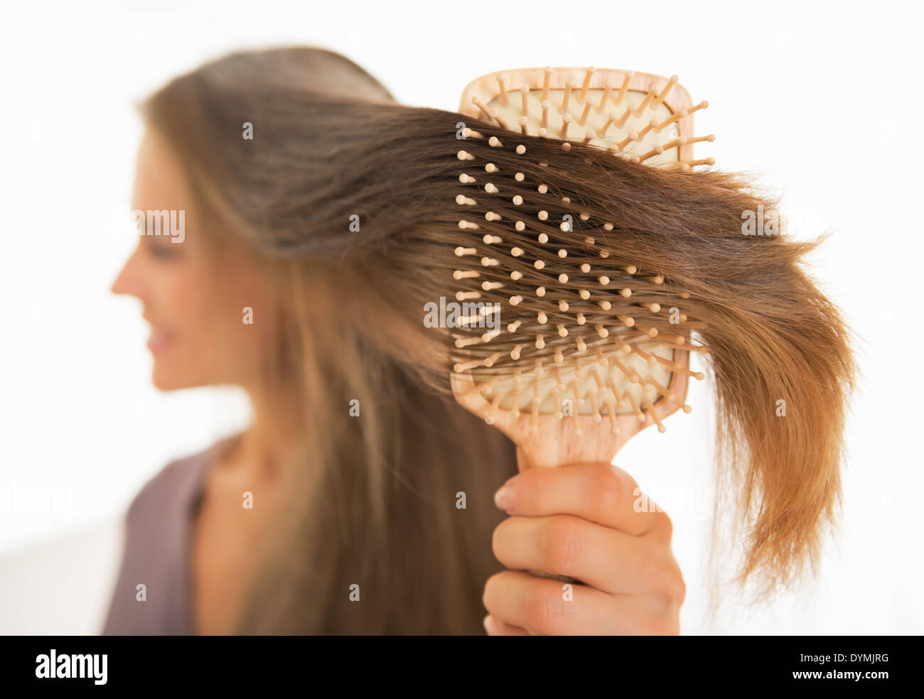Closeup on young woman combing hair Stock Photo - Alamy