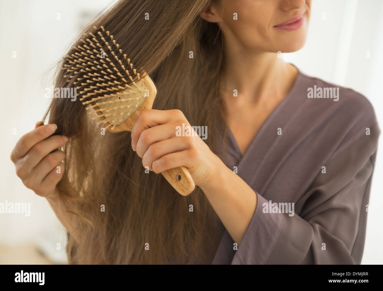 Closeup on young woman combing hair Stock Photo - Alamy