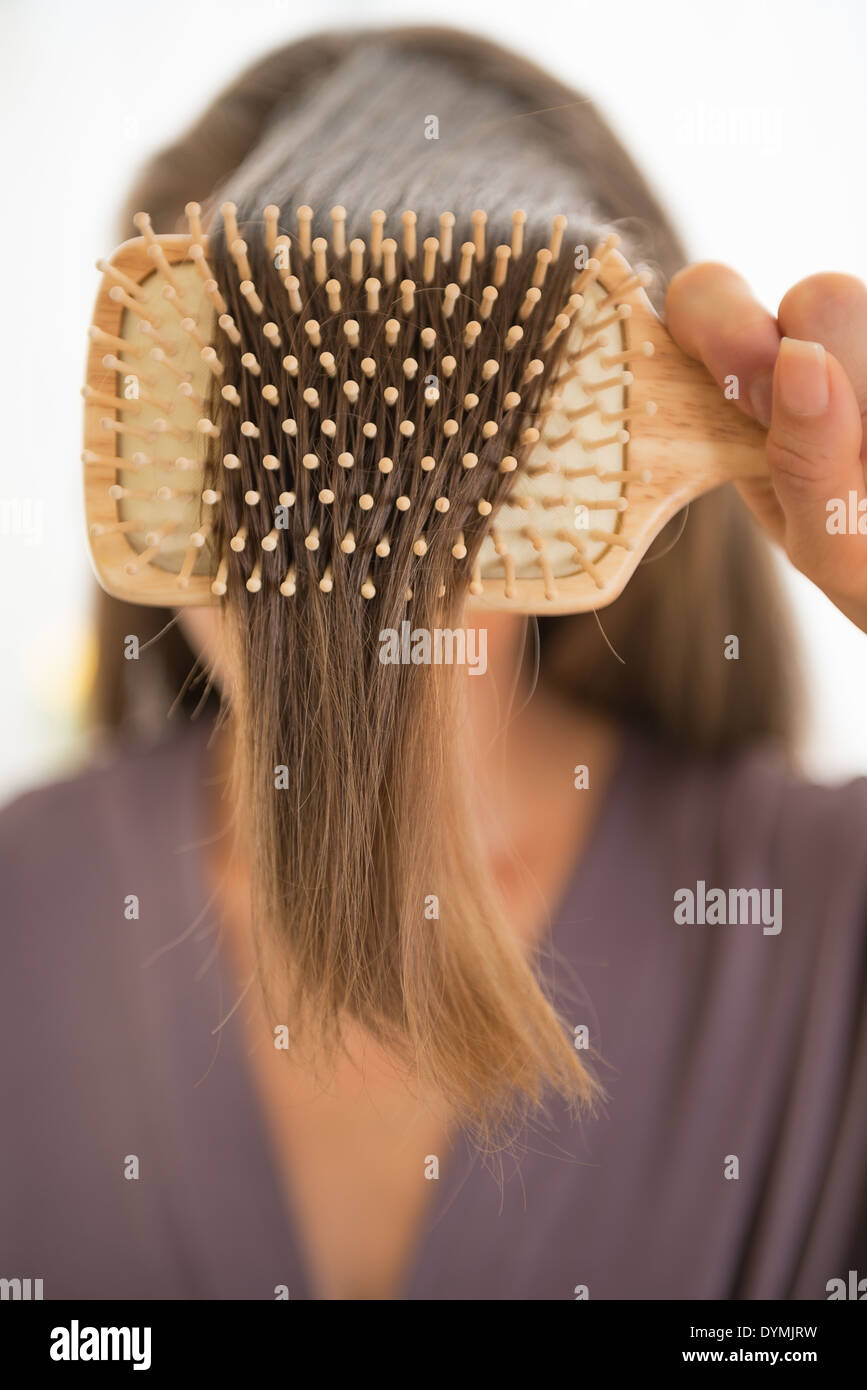 Closeup on young woman combing hair Stock Photo - Alamy