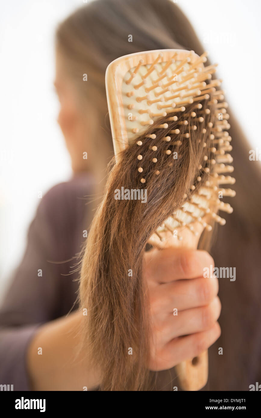 Closeup on young woman combing hair Stock Photo - Alamy