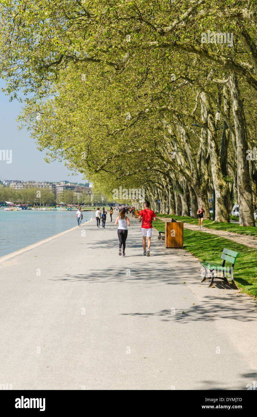 People on the tree lined waterfront promenade of Lake Annecy, Annecy ...