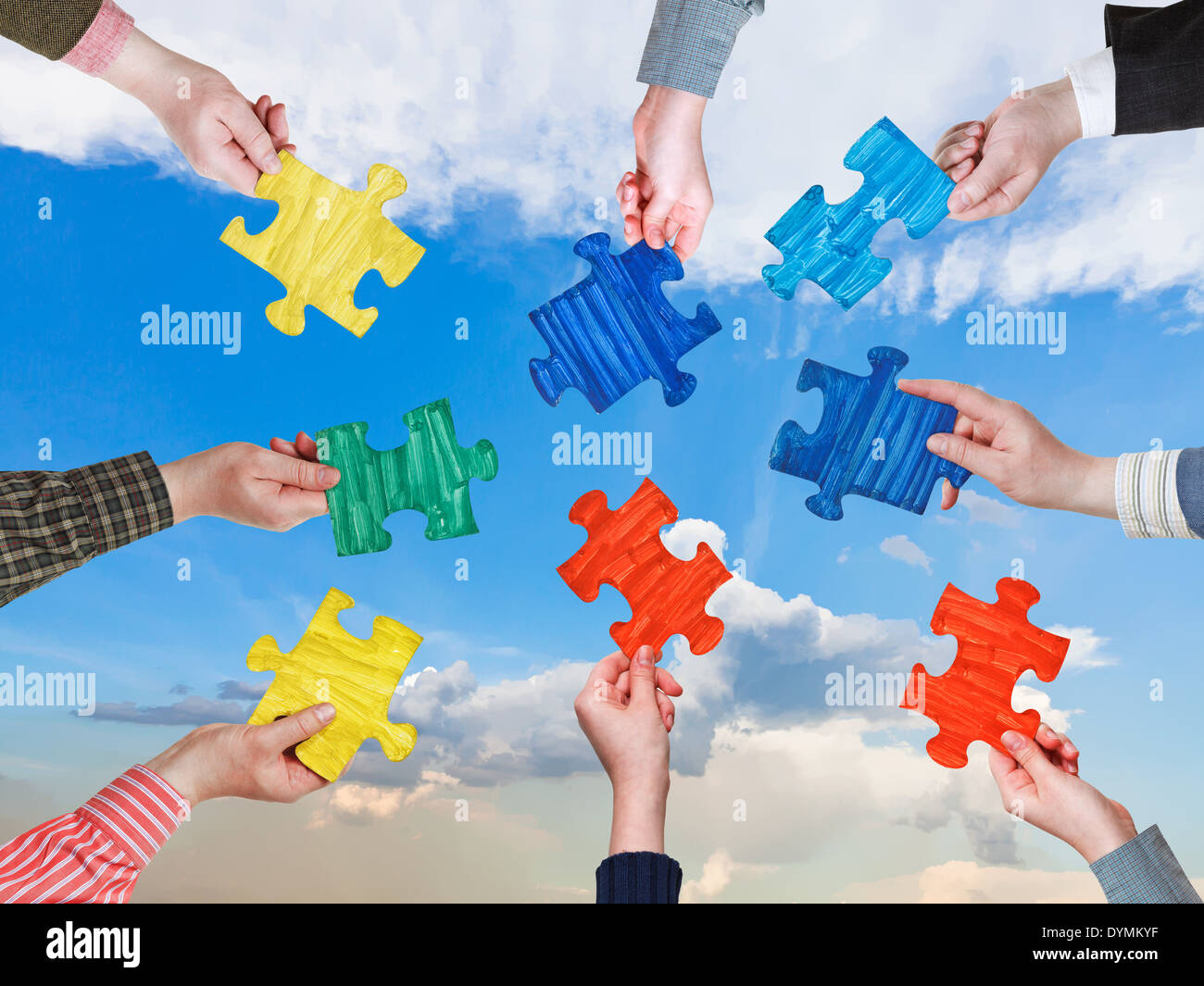 circle of people hands with different puzzle pieces with afternoon blue ...