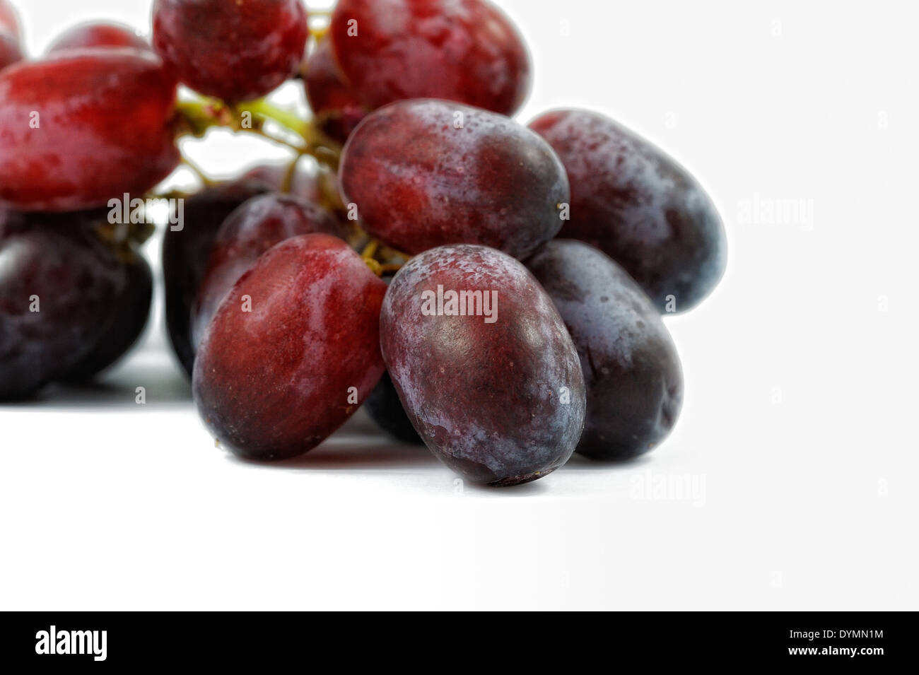 Red grapes on a white studio background Stock Photo - Alamy