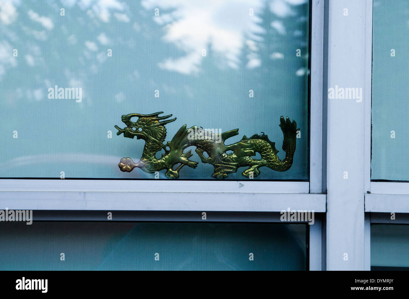 Brass dragon in window Stock Photo - Alamy