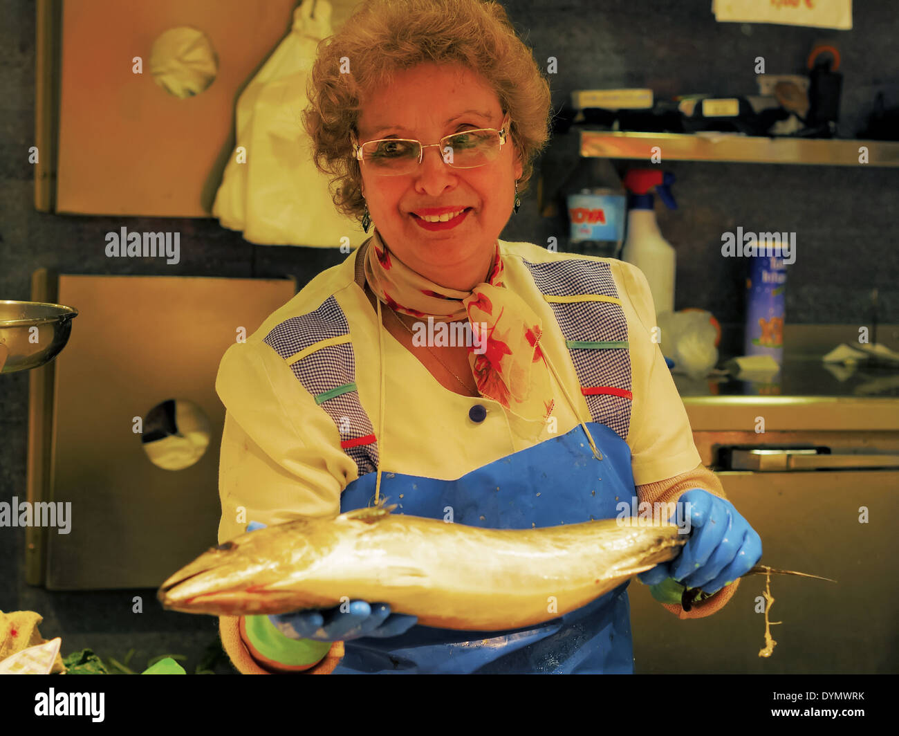 Unidentified saleswoman holding a fresh fish in Mercat de Santa ...