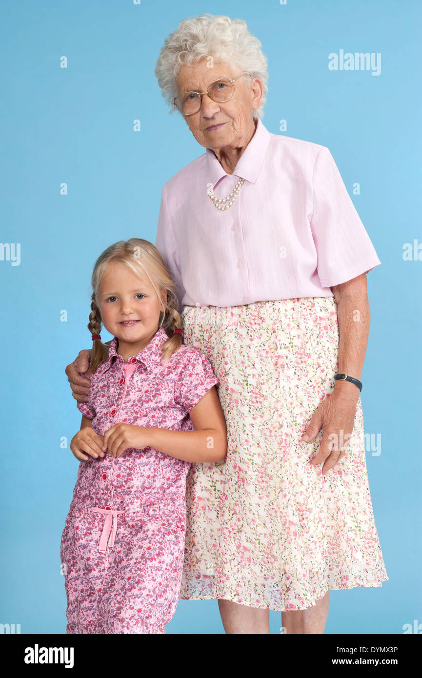 great grandmother and grandchild on blue background Stock Photo - Alamy