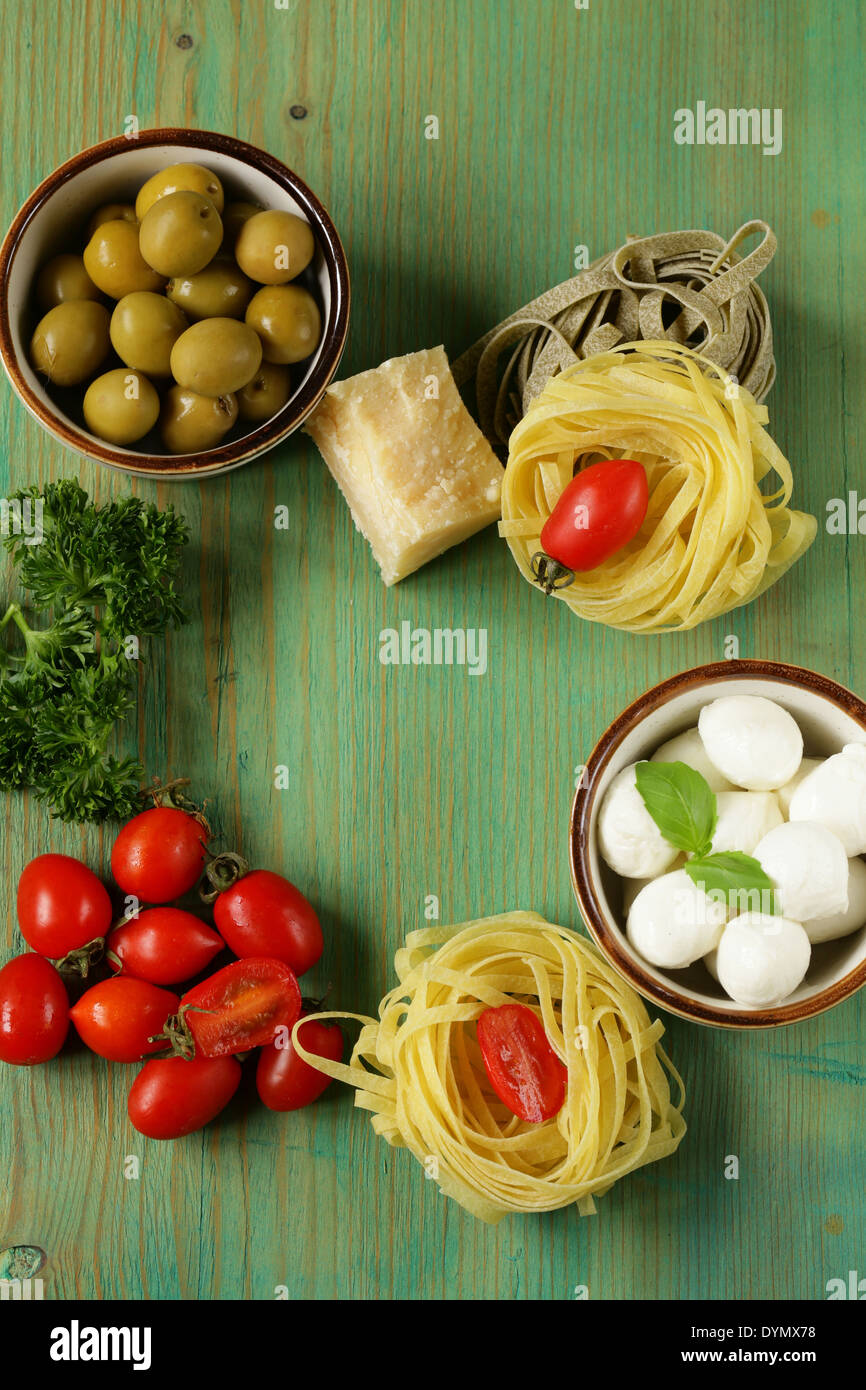 Italian still life - olives, mozzarella cheese, pasta, tomatoes Stock ...