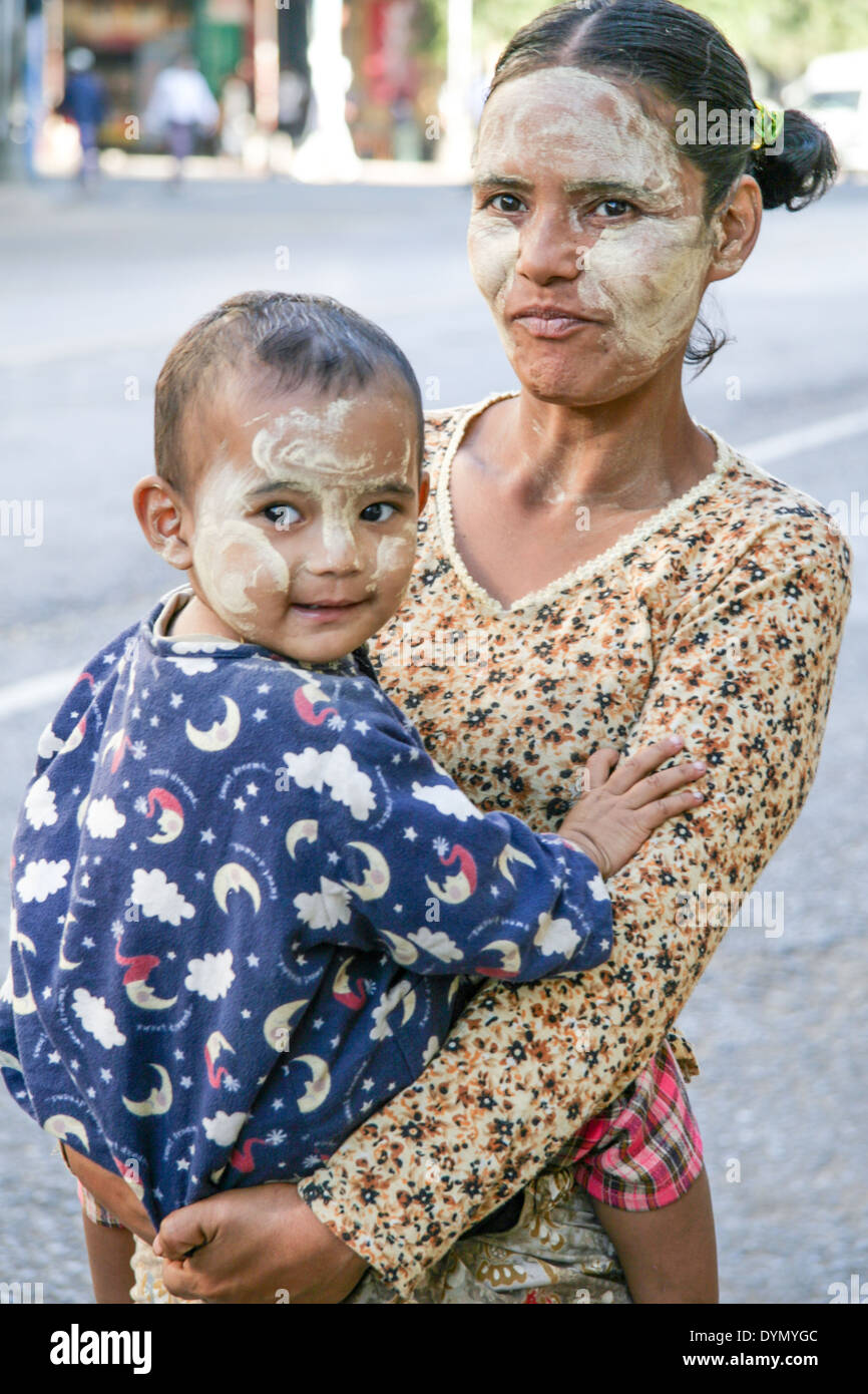A Mother and a with baby selling goods in the streets of Yangon, Burma ...