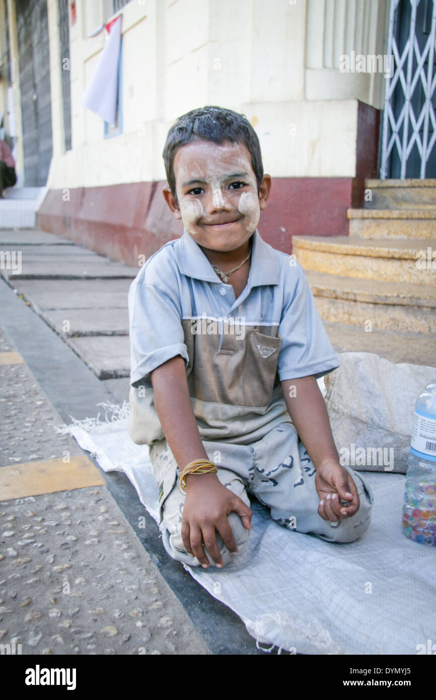 A young boy selling goods in the streets of Yangon, Burma Stock Photo ...