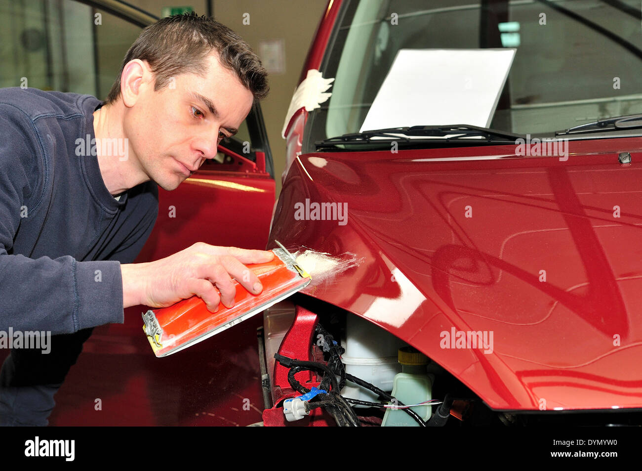 Car mechanic fixing a red car hi-res stock photography and images - Alamy