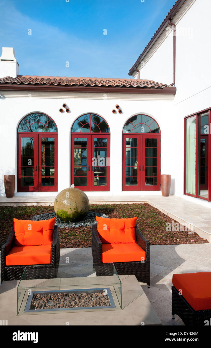 Beautiful landscape design with fireplace behind luxury upscale home in Windermere, Florida ...