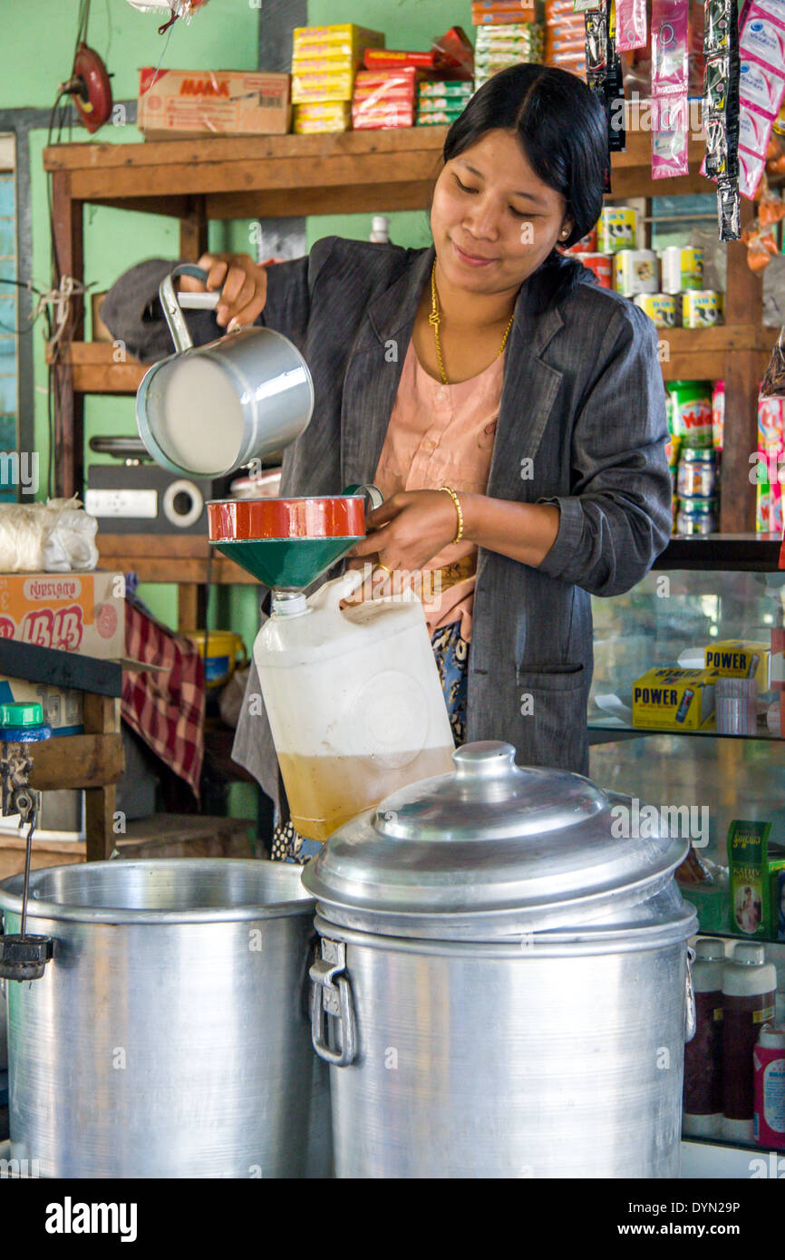 Women in a store in Mandalay selling cooking oil Stock Photo - Alamy
