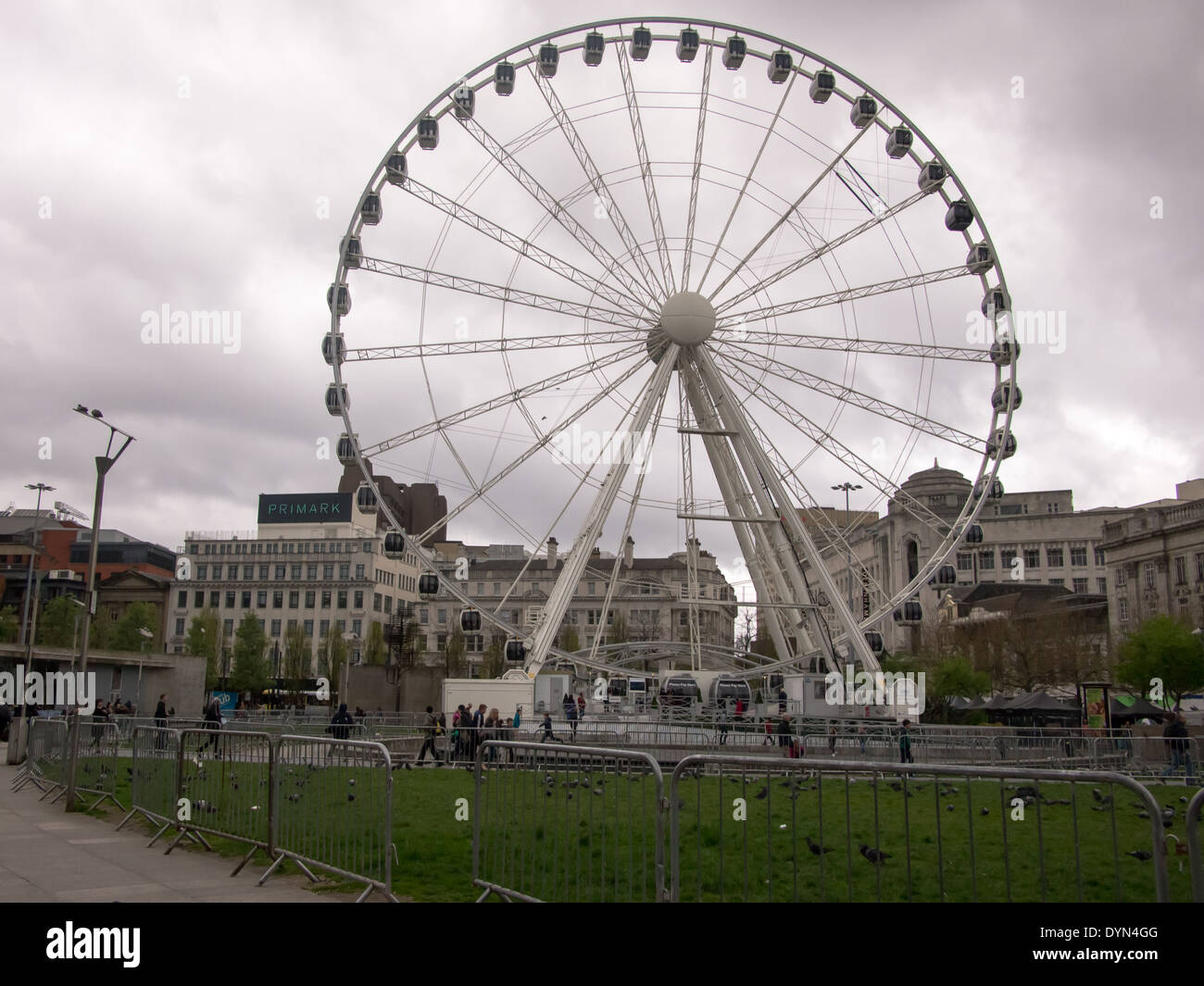 The wheel of Manchester in Piccadilly gardens against a grey cloudy sky ...